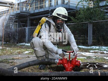 Rescuer team training chemical decontamination: fire truck parked ...
