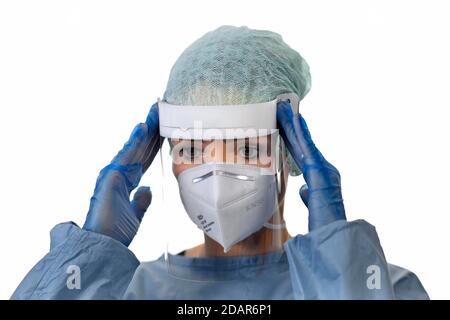 Medical staff overworked, gestures, hands over head, corona crisis ...