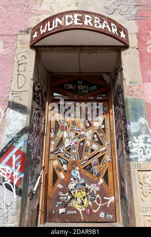 Door with many stickers, entrance to the alternative pub Wunderbar ...