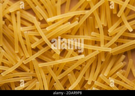 short thin vermicelli on the whole background. texture of dry yellow ...
