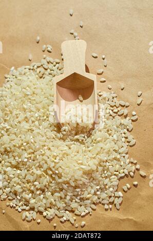 a pile of scattered white rice on the kitchen table, white uncooked ...