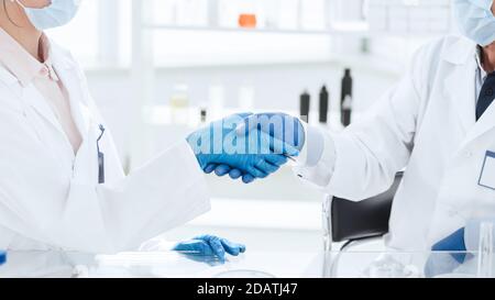 close up. Microbiology scientists shaking hands. science and health ...