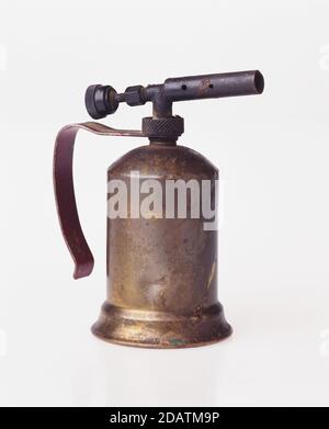 old and vintage blow torch isolated on black background with rust and ...