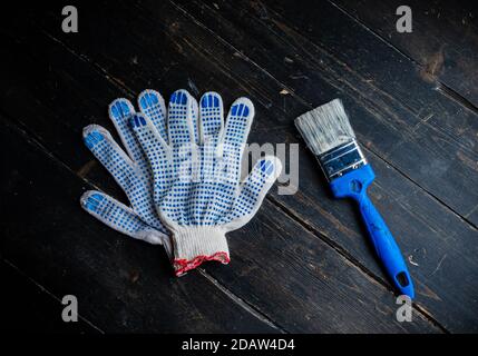 blue paintbrush on yellow leather working gloves isolated Stock Photo ...