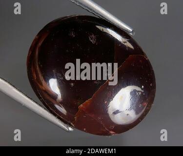 Natural almandine on a gray background. Natural stone garnet Stock ...