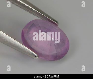 Natural amethyst on gray background Stock Photo - Alamy