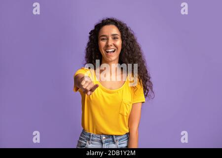 Gotcha. Positive brunette woman pointing finger at camera and laughing ...