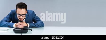 Sad Businessman Waiting For A Call On Landline Stock Photo - Alamy