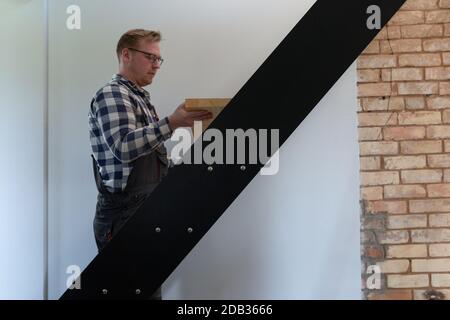 Home improvement handyman building staircase in a natural light Stock ...