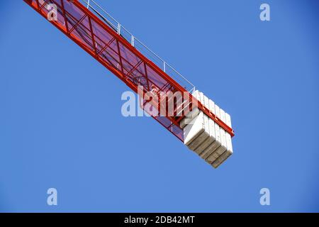 Heavy cement blocks are used as counterweights to balance a tower crane ...