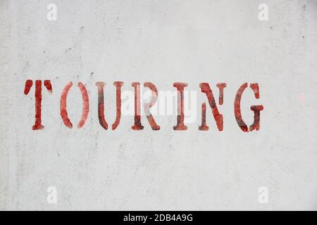 touring sign written on wall . close up Stock Photo - Alamy