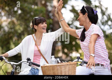 two friends on bikes outdoors smiling Stock Photo - Alamy