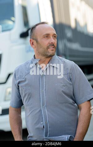 Handsome driver near big modern truck outdoors Stock Photo - Alamy