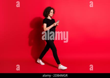 Photo of funky wavy brunette lady look empty space hold telephone wear ...