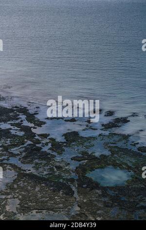 A beautiful view of a lighthouse next to the cliffs at the shore Stock ...
