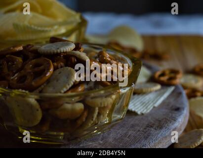 Salty snacks, party mix. An assortment of crispy appetizers in bowls on ...