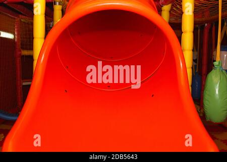 Red Slide in Indoor Kids Playground Stock Photo - Alamy