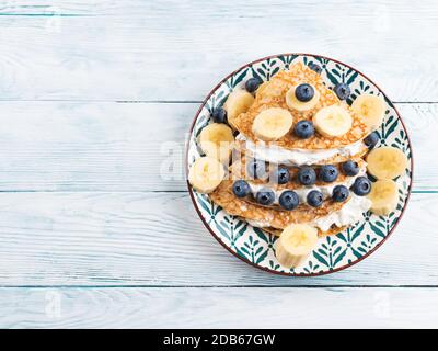 Christmas tree shaped crepes with quark, blueberry Stock Photo - Alamy