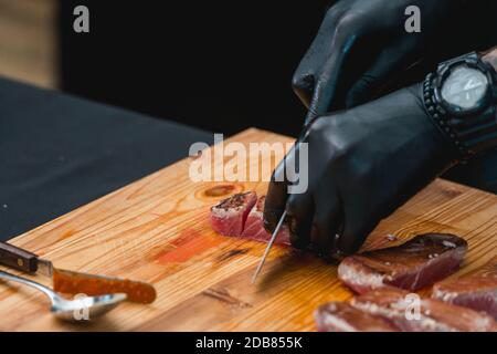 lightly greased tuna fish on wooden plank Stock Photo - Alamy