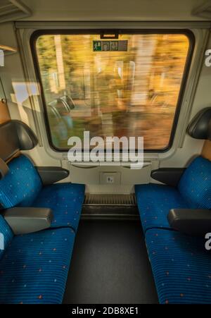 Red seat in sunny compartment of fast passenger train from Pilsen to ...