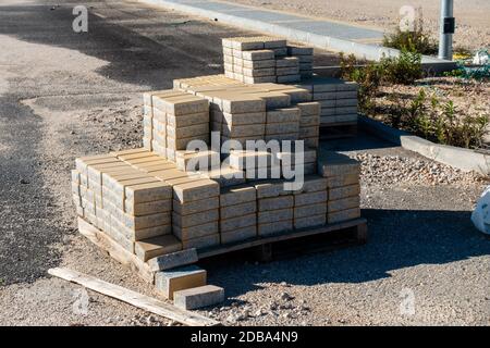 paving slabs stacked at roadside ready for use Stock Photo - Alamy