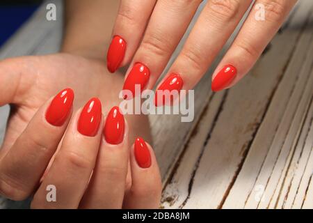 fashionable red manicure on long beautiful nails Stock Photo - Alamy