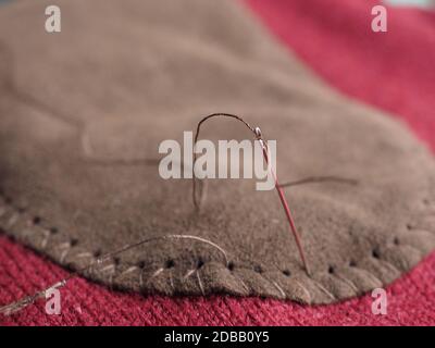 patch sewing detail with selective focus on needle's eye Stock Photo ...