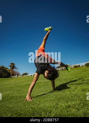 Young Man Doing A Cartwheel On The Beach Stock Photo - Alamy