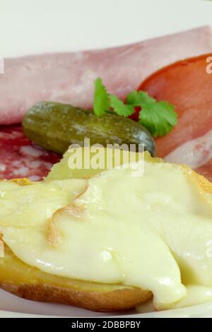 plate of raclette cheese, potatoes and cold cuts Stock Photo - Alamy