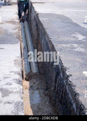 installing concrete drains on the side of the road Stock Photo - Alamy