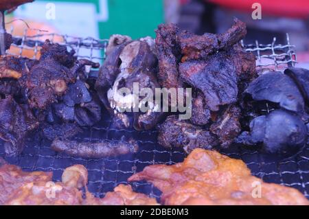 Barbecued dog head and meat - Phnom Penh, Cambodia Stock Photo - Alamy