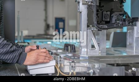 quality engineer controls an instrument for 3D measurement of plastic ...