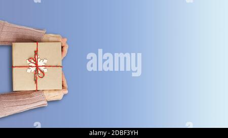 one craft wrapped gift over red background Stock Photo - Alamy