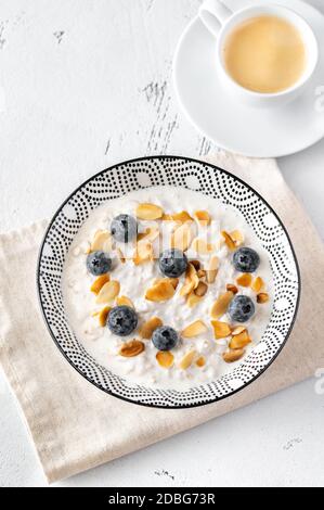 Portion of homemade Bircher muesli with cup of coffee Stock Photo - Alamy