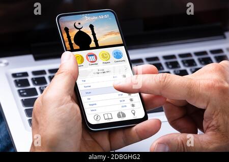 Man Using Muslim Prayer App On Mobile Phone Stock Photo - Alamy