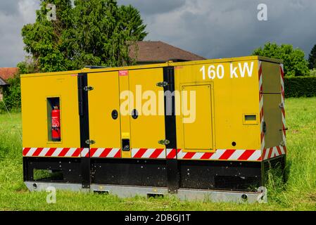 Power generator for gasoline in a yellow housing standing in the glove ...