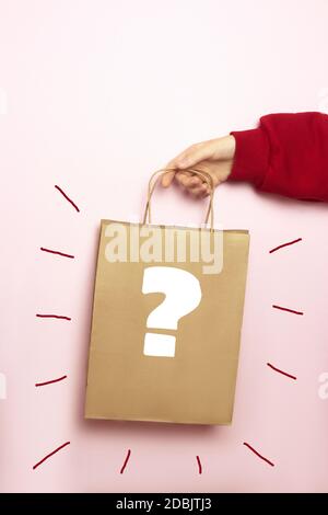 A woman holds a craft bag with Christmas tree branches in the winter ...