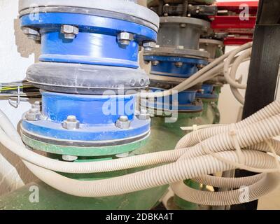 Close detail of pipe flanges and valves from a chemical industry plant ...