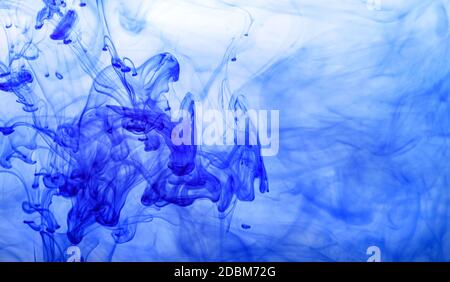 Blue ink injected into water from syringe, colour mixing with water ...