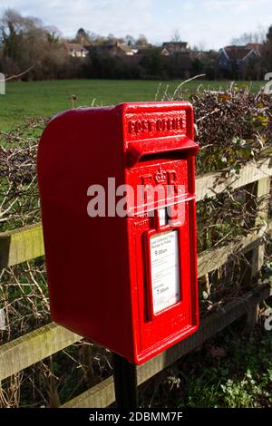 Freshly painted bright red Royal Mail post box with gold lettering ...