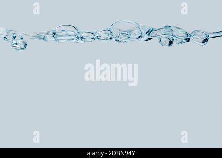 Full-size side view of a row of air bubbles on the water surface ...