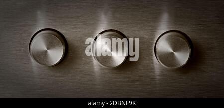 closeup of three electronic round switches Stock Photo - Alamy