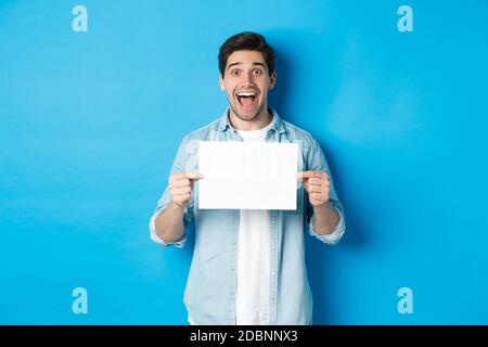 Excited man making fantastic announcement, showing logo or sign on ...