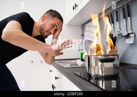 Bad Cooking Accident Disaster In Kitchen. Pot Fire Stock Photo - Alamy