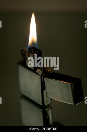 Close up chrome lighter with windproof over the military object in the ...