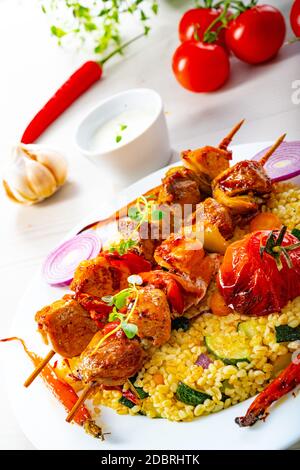 Shish kebabs with vegetables and bulgur Stock Photo - Alamy