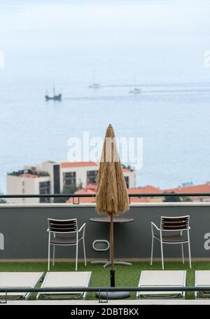 a balcony with chairs overlooking the water and buildings on both sides ...