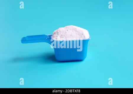 Detergent powder with measuring spoon for clothes washing. Laundry ...