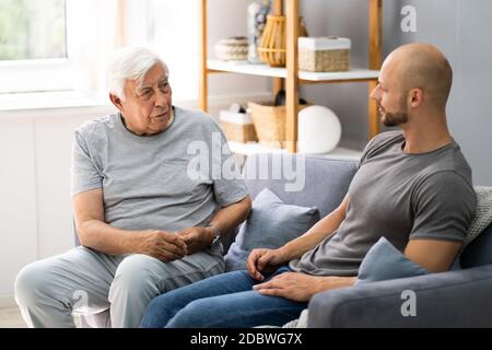 Grandpa Talking To His Grandson In Living Room Stock Photo - Alamy