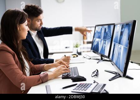 Businesswoman Watching CCTV Footage On Laptop Stock Photo - Alamy